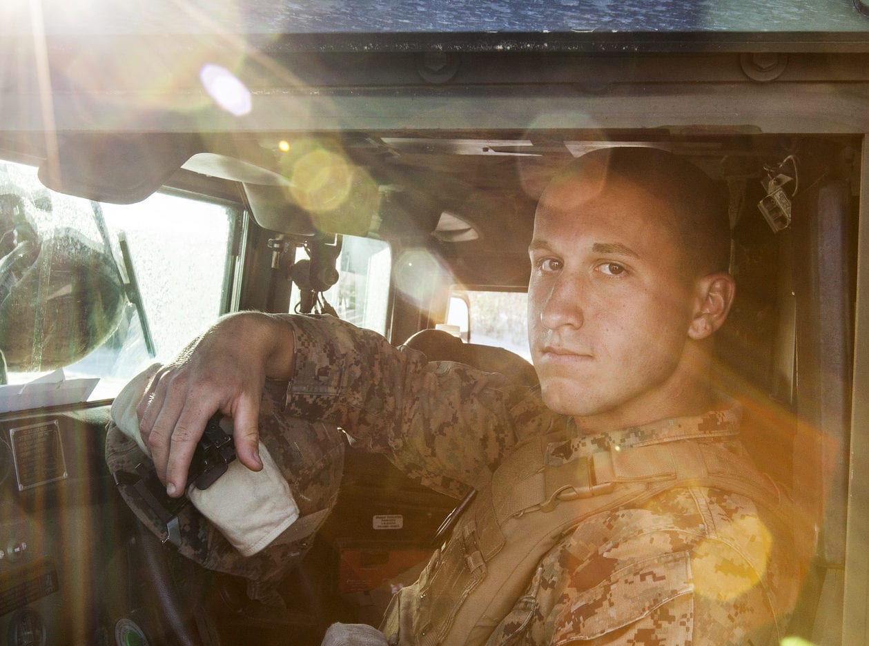 A Marine logistics embarkation specialist sits inside a High Mobility ...